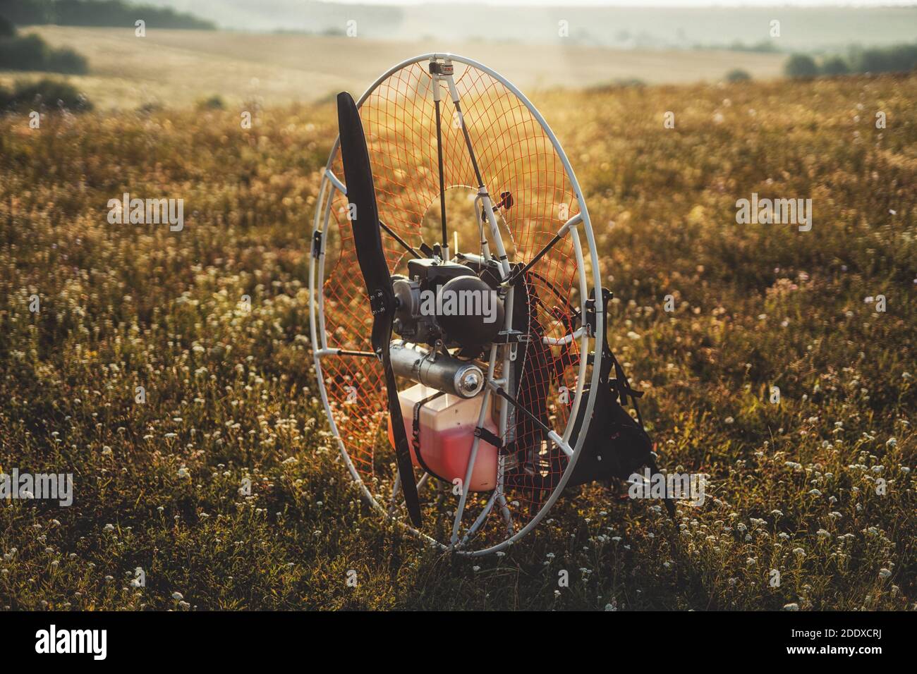 Closeup of a petrol-powered paramotor with a propeller and protection ...