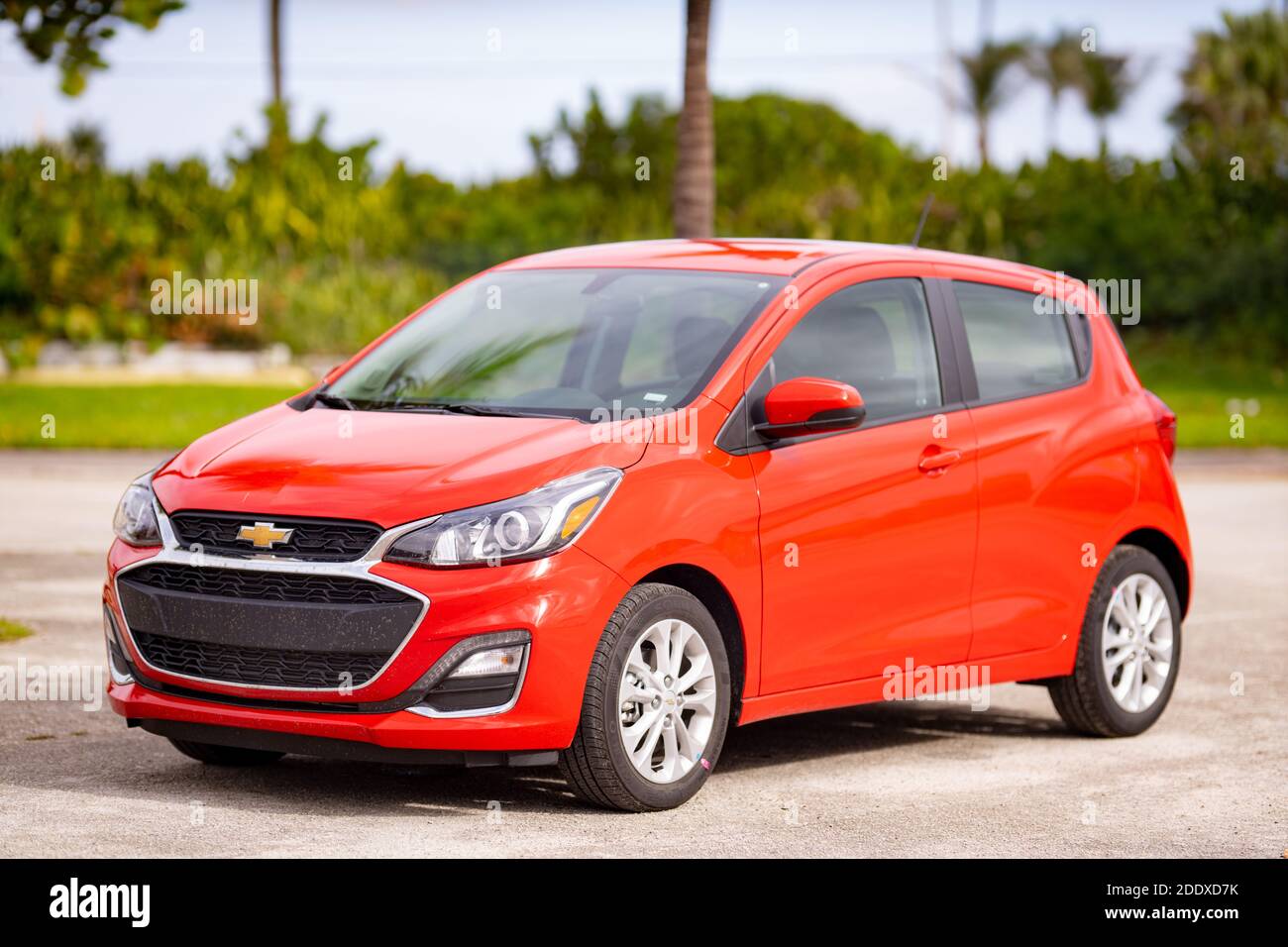 Red Chevy spark car blurry background Stock Photo - Alamy
