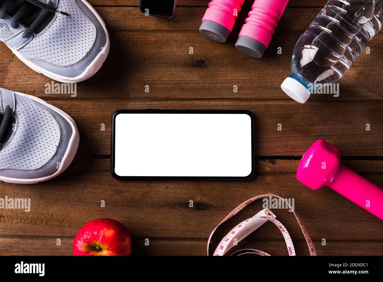 Top view of pair sports shoes, water, apple, jump rope and smartphone ...