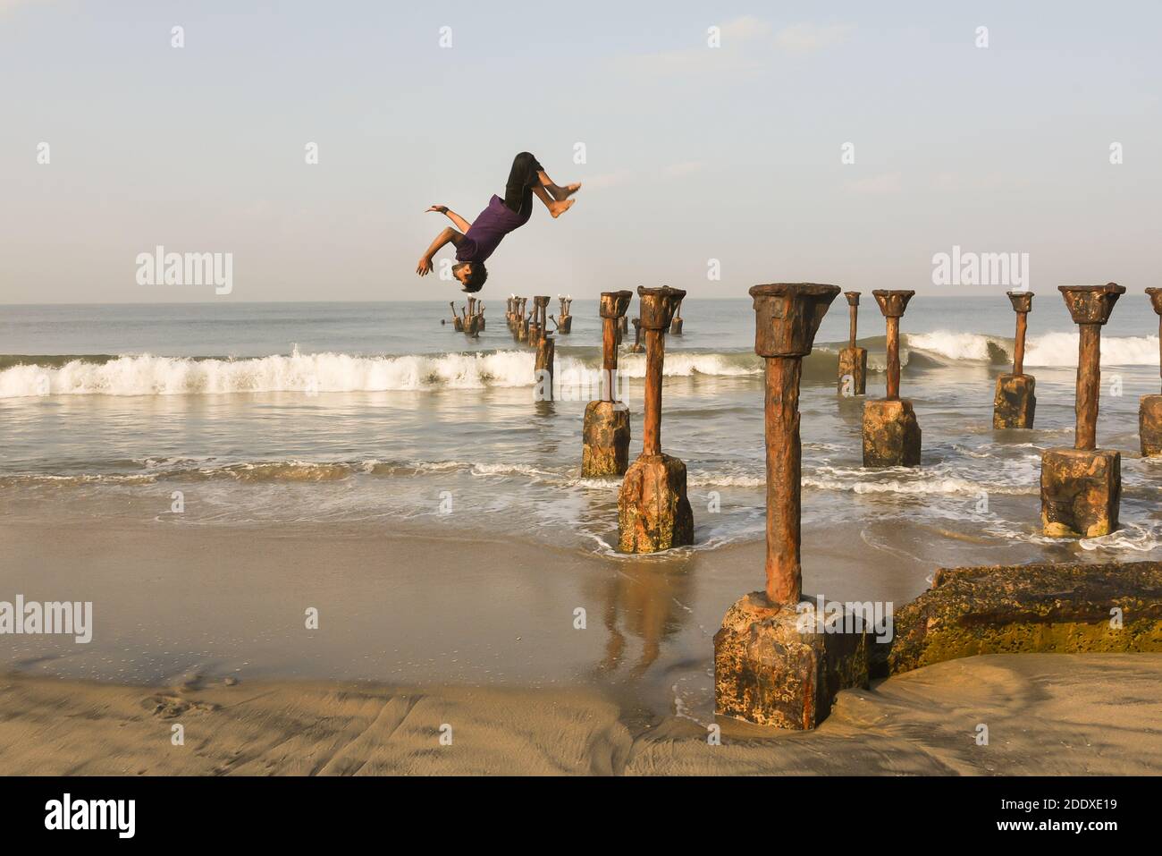 Kozhikode, Unidentified Indian men doing a morning walk backflip on the ...
