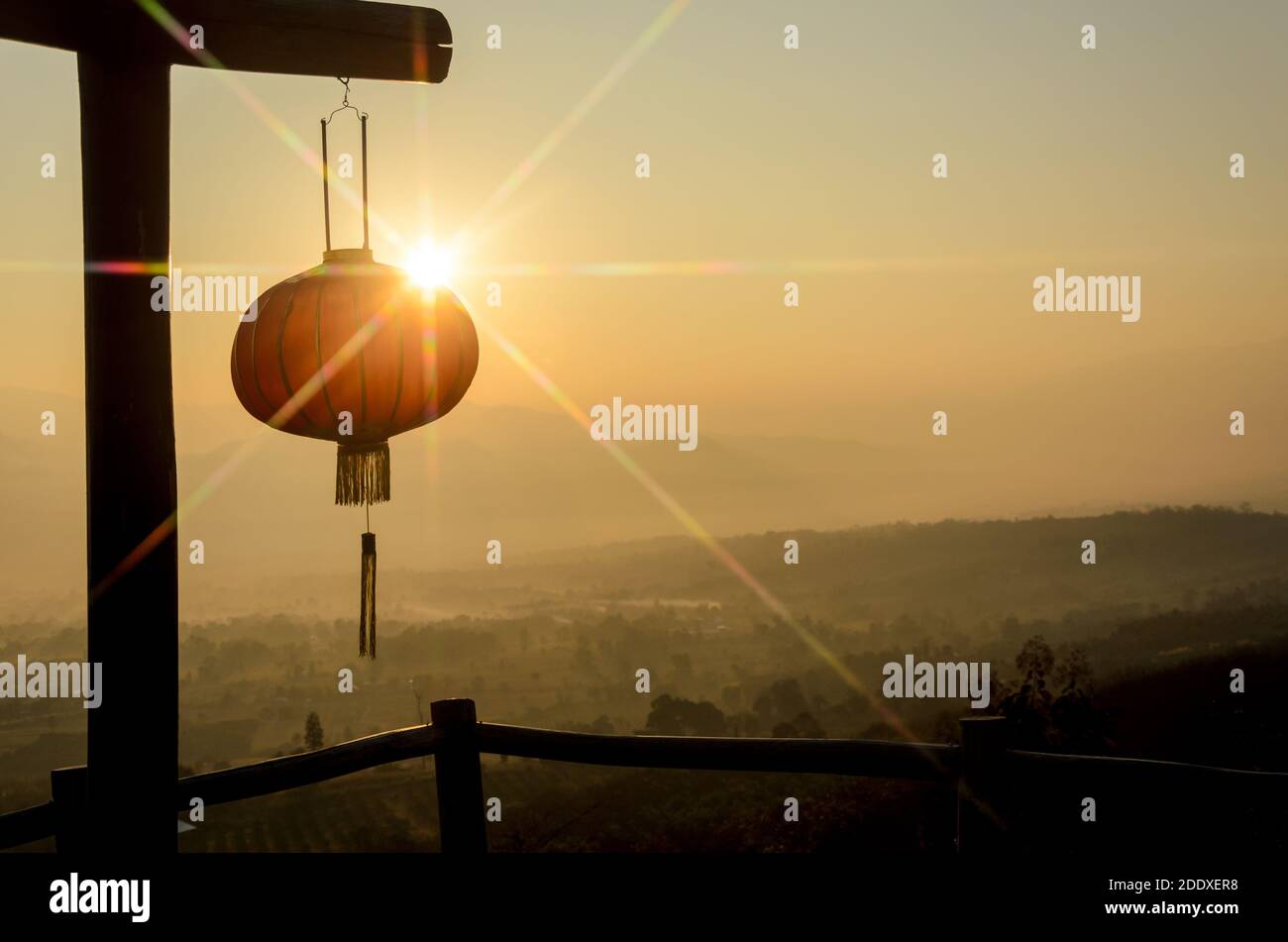 Chinese lanterns with rays of sunrise and mountain view Stock Photo - Alamy