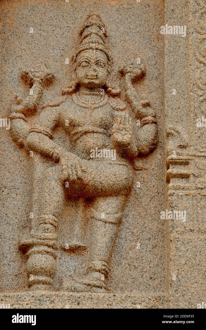 Carving idols on the outer wall of Hazara Rama Temple, Hampi, Karnataka ...