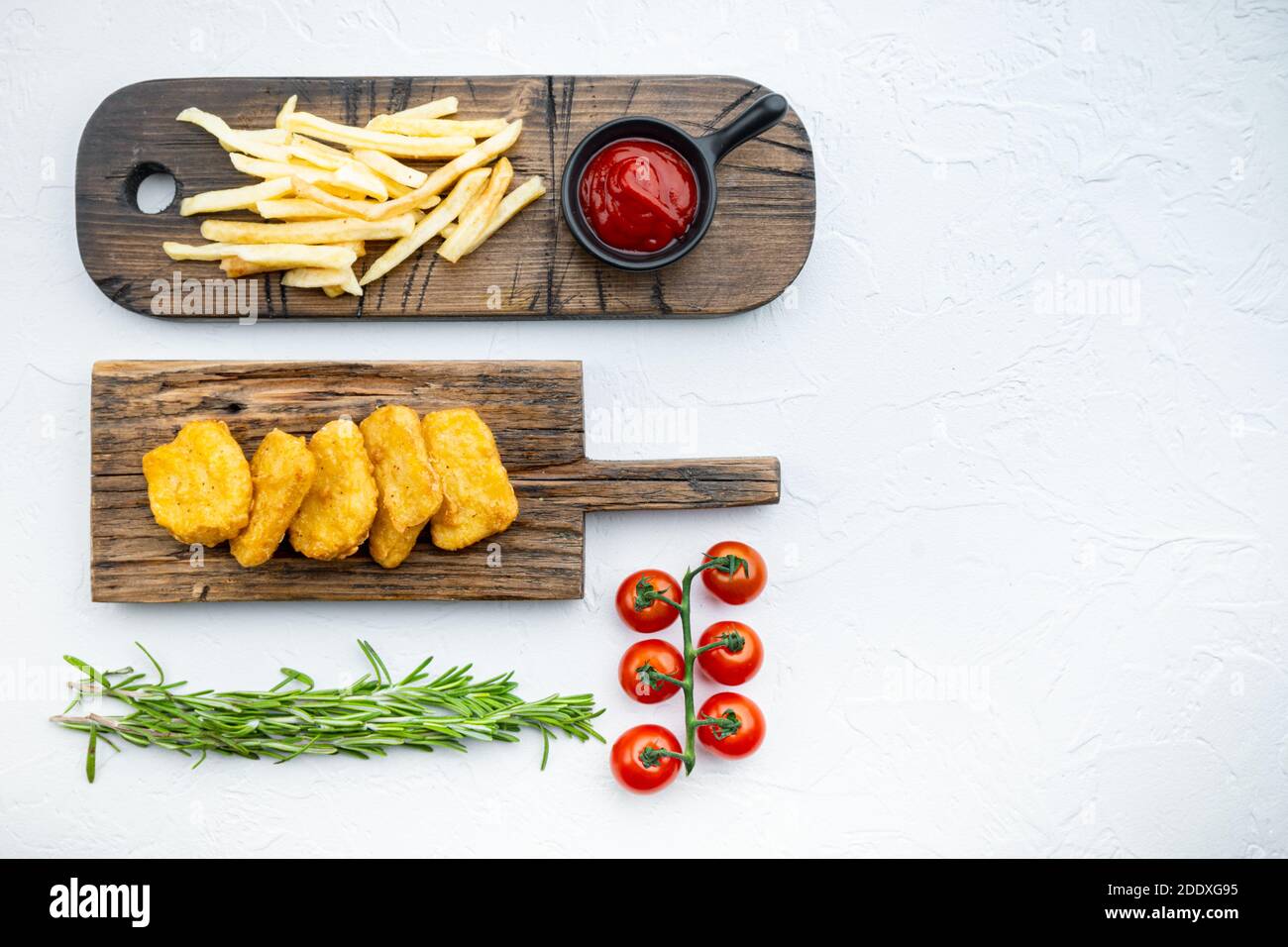 Chicken nuggets with fries on white background, top view, with copy ...