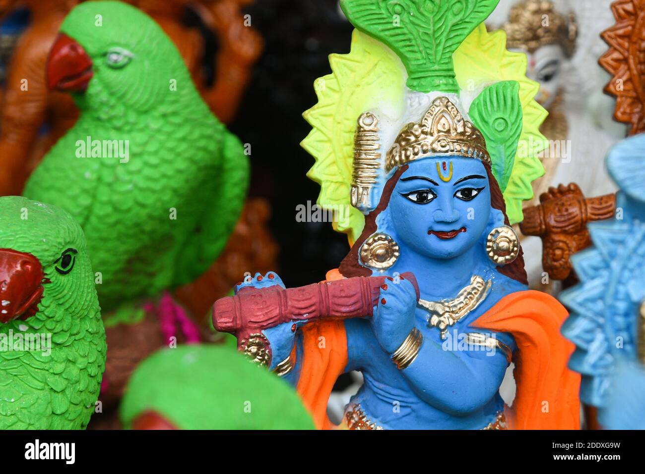 Many colorful statue sculptures of Hindu god, lord Krishna in an street ...