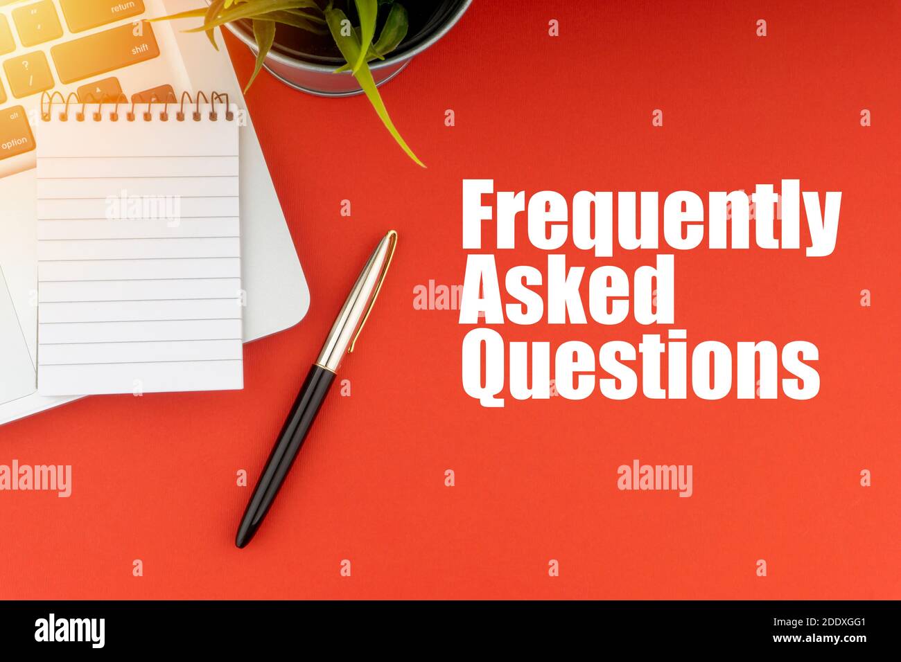 FREQUENTLY ASK QUESTIONS or FAQ text with notepad, laptop, fountain pen ...