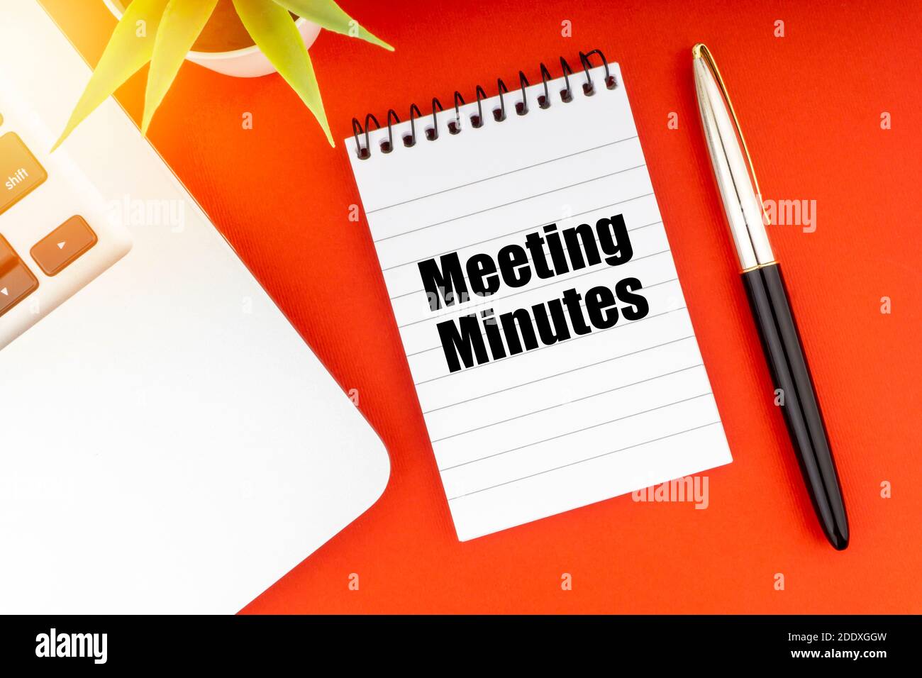 MEETING MINUTES text with notepad, laptop, fountain pen and decorative ...