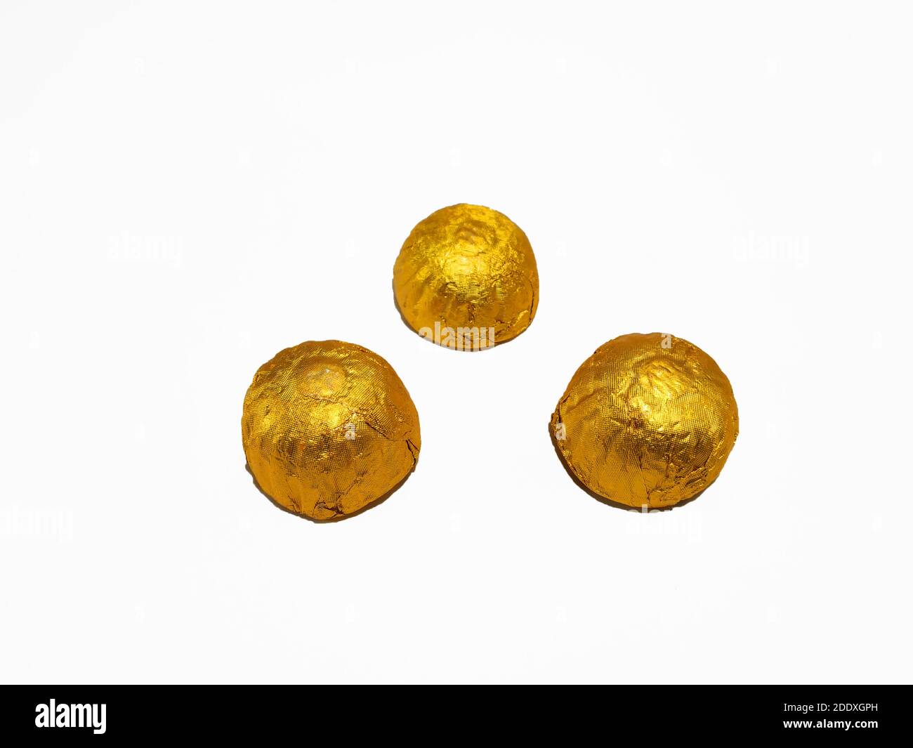 Sweet chocolate candy wrapped in golden foil isolated on white ...