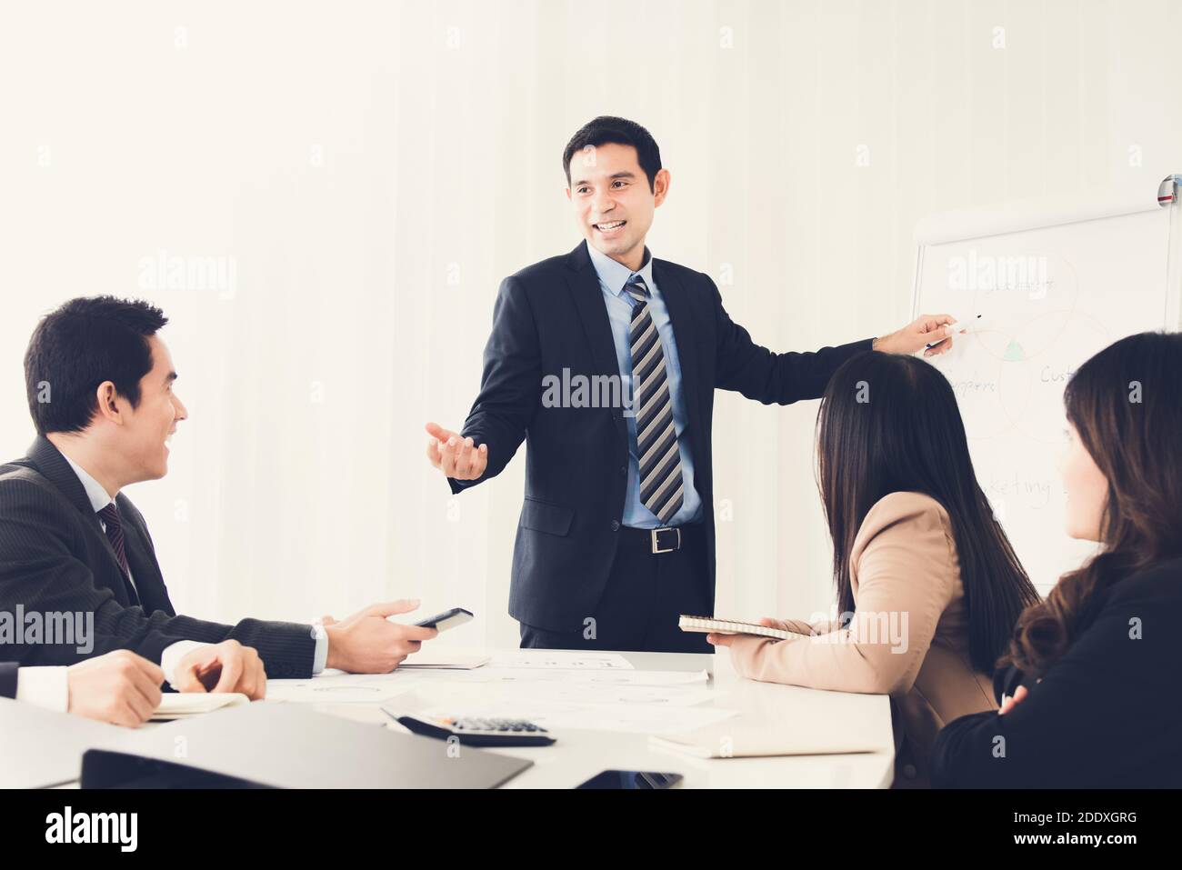 Businessman as a meeting leader giving presentation in the meeting room ...