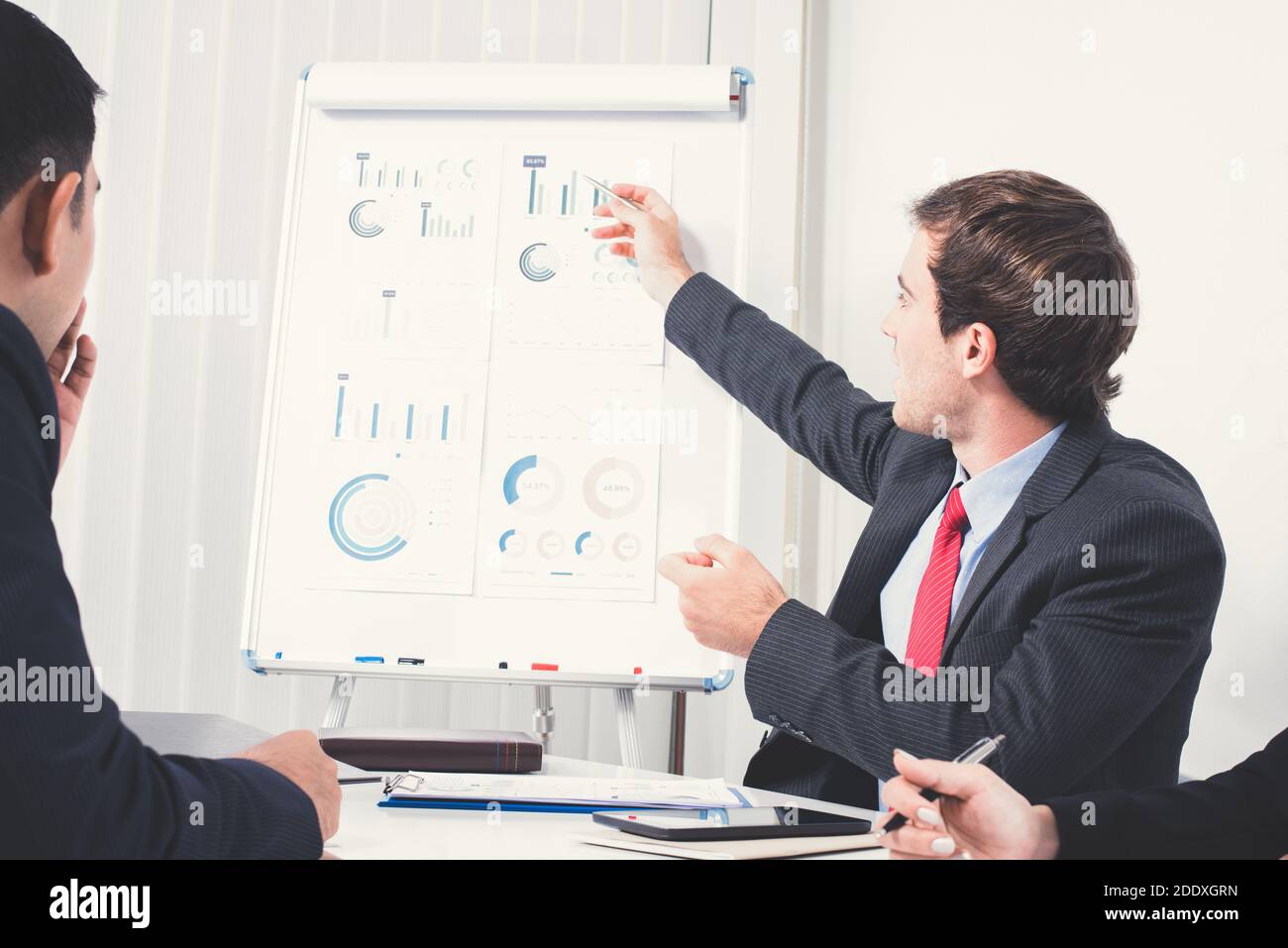 Young businessman as a meeting leader presenting his work Stock Photo ...