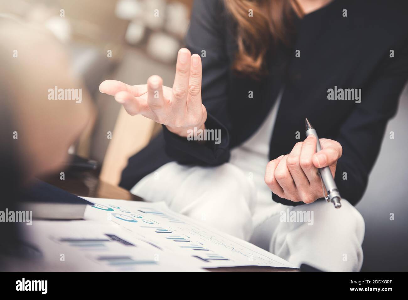 Businesswoman using hand gesture while sitting and talking in the ...