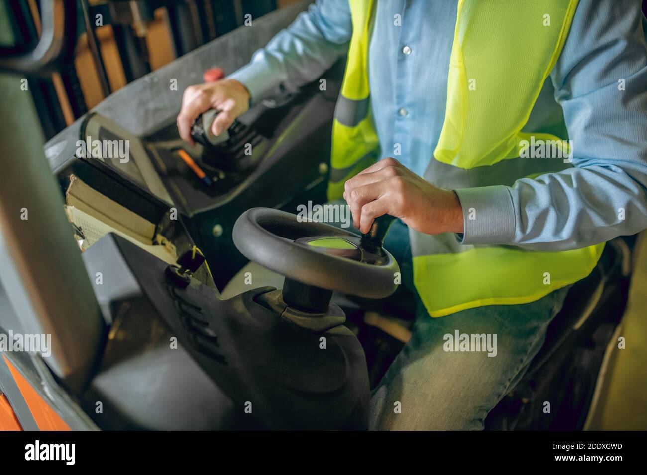 Close up picture of amn sitting in the loader Stock Photo - Alamy