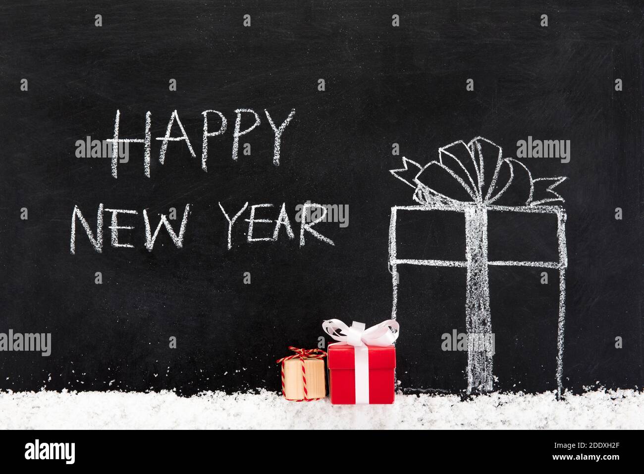 HAPPY NEW YEAR text with gift boxes, creative idea, on blackboard Stock ...