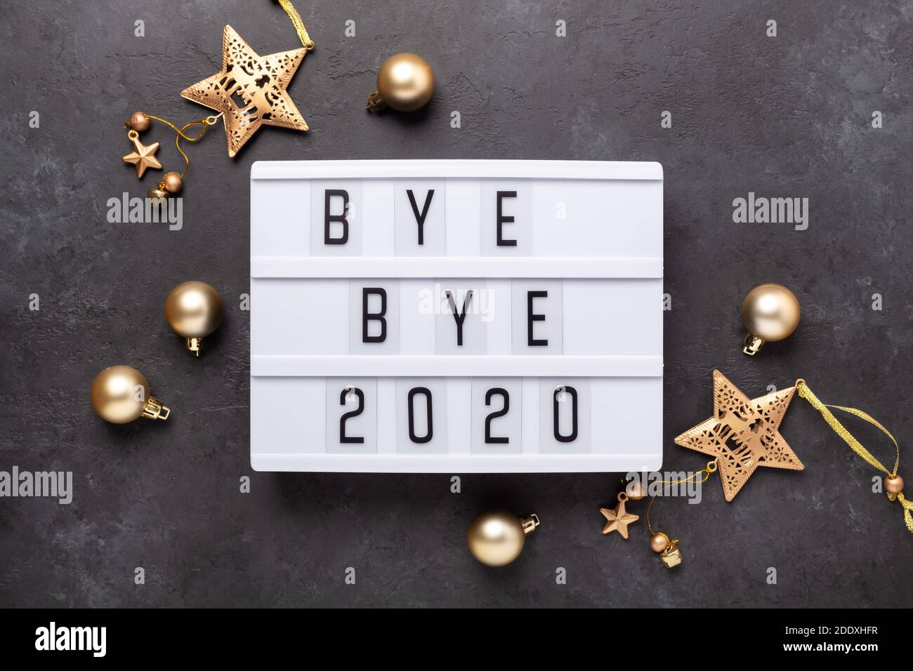 Lightbox with text BYE BYE 2020 with gold decoration on dark background ...