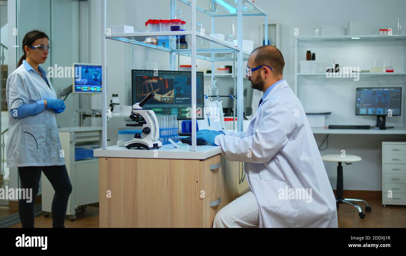 Scientist working in modern equipped laboratory cheching virus ...