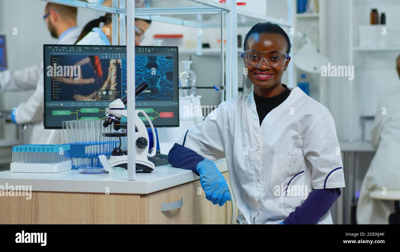 Professional black woman scientist looking at camera smiling in modern ...