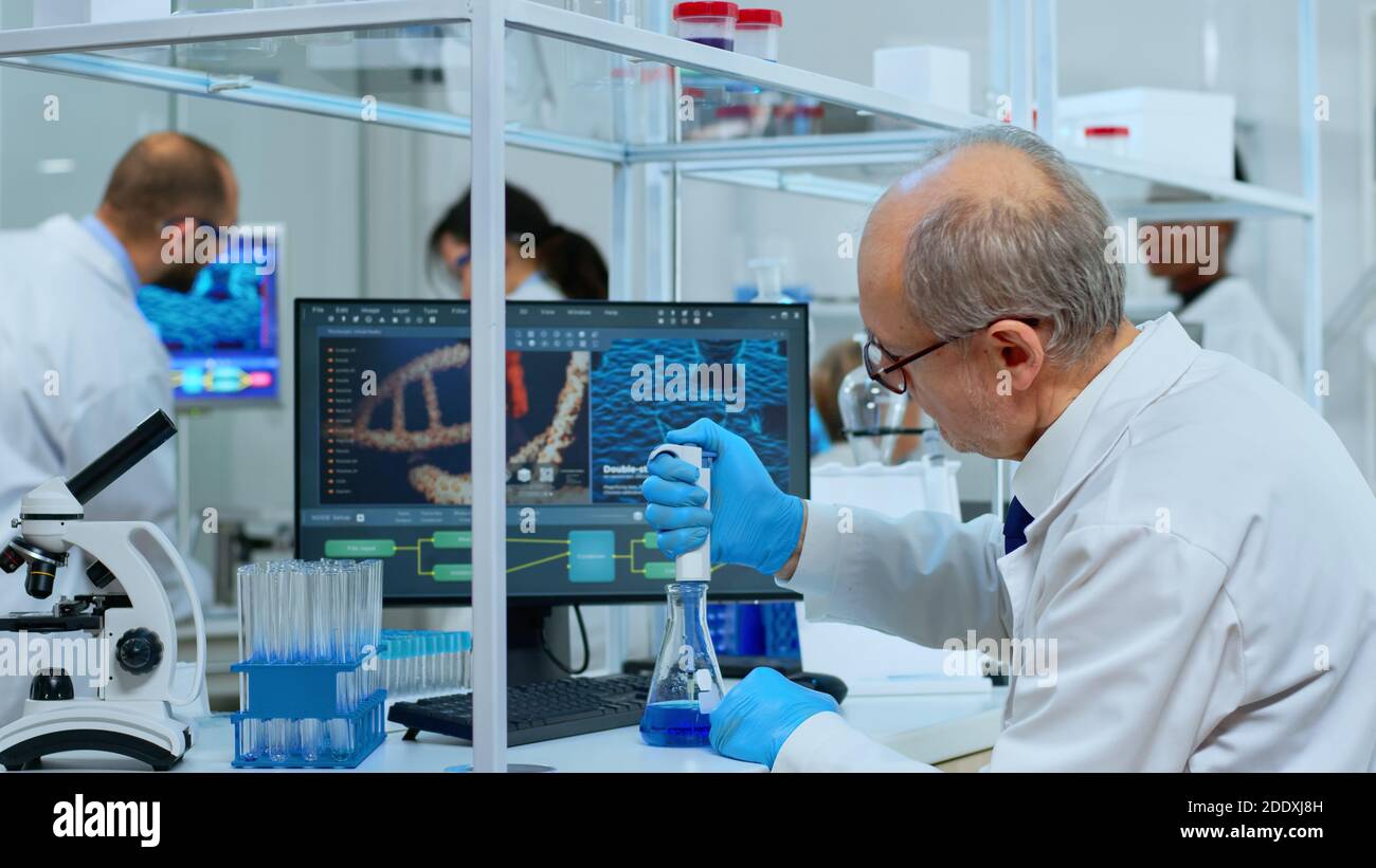 Elderly man scientist using micropipette hi-res stock photography and ...