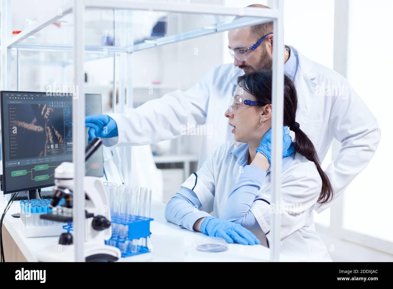 Determined professional scientists wearing uniform working with ...