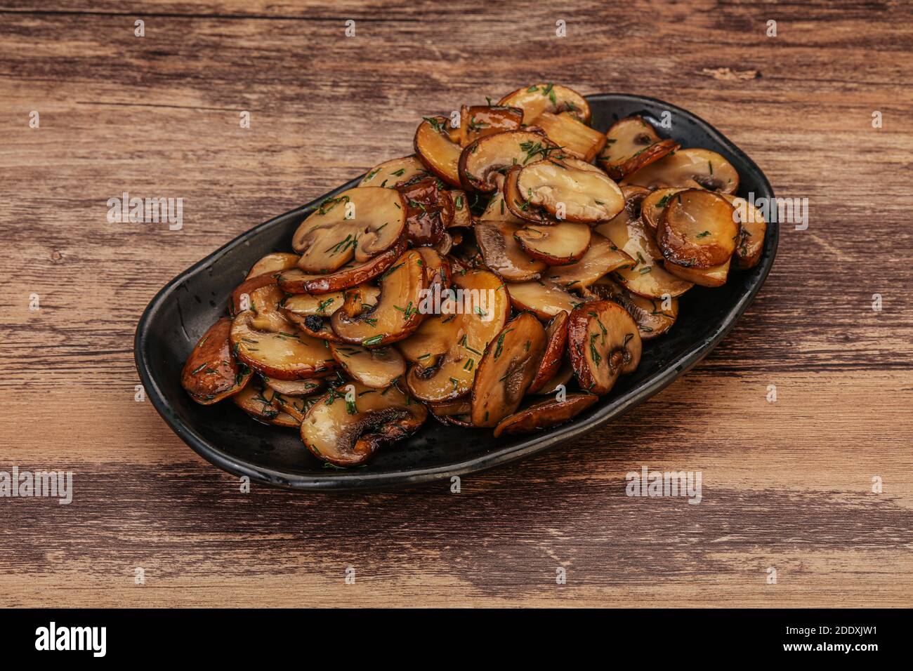 Roasted champignon with herbs and spices in the bowl Stock Photo - Alamy