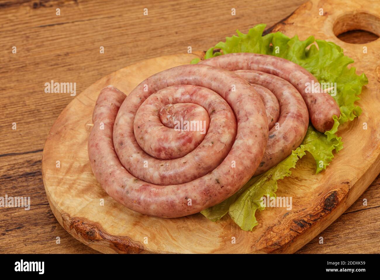 Raw pork sausage ring for grill Stock Photo - Alamy