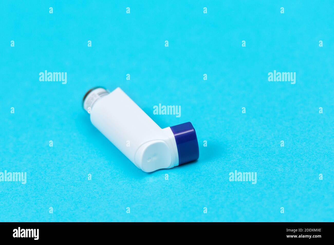 Medicine for asthma. The inhaler with the medicine is on a blue ...