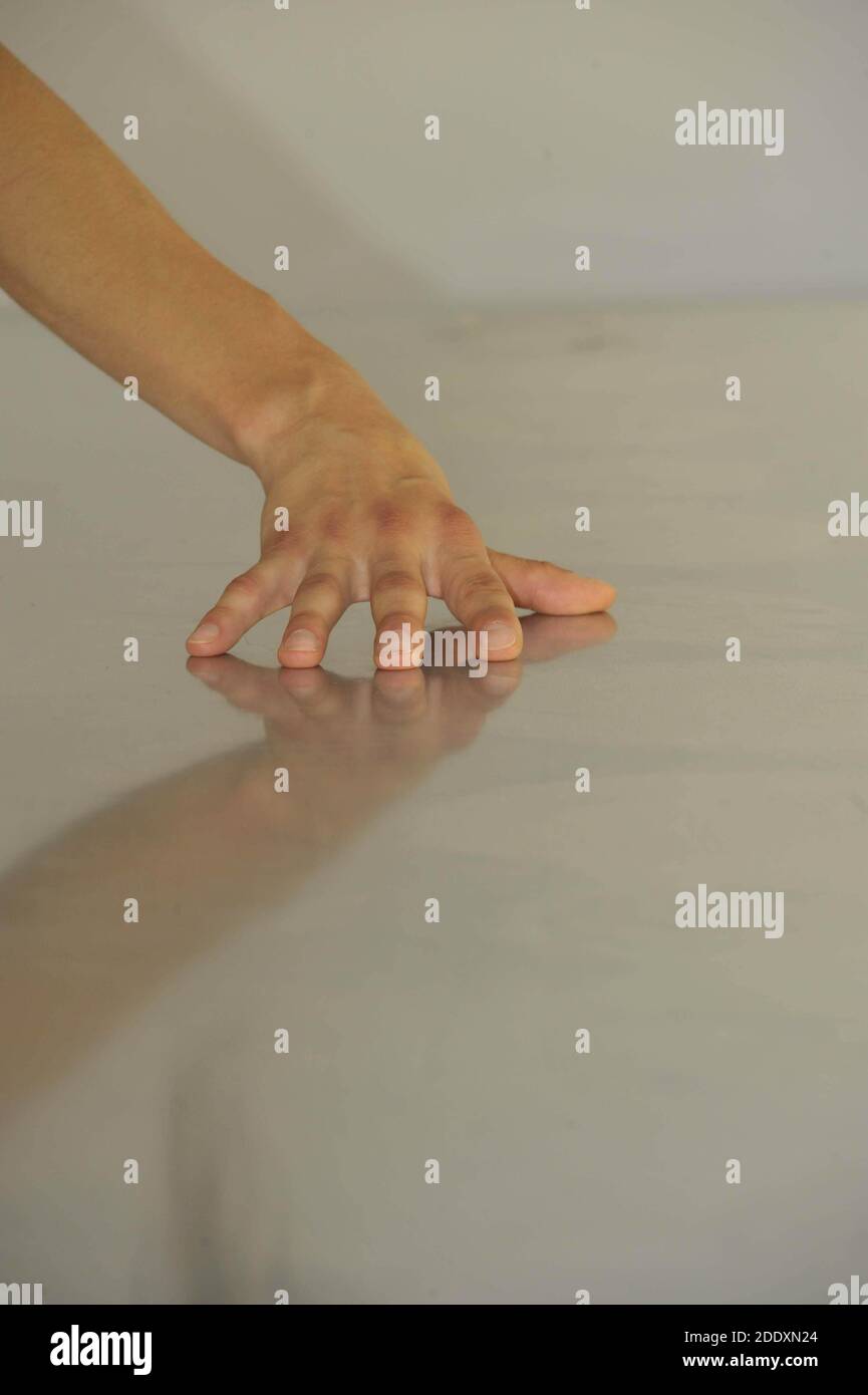 a hand touching reflecting floor, human tactile and haptic perception ...