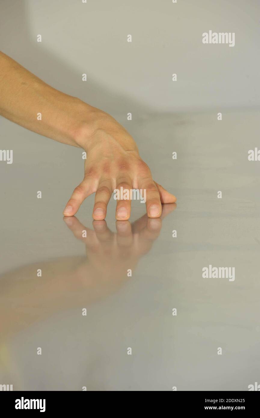 a hand touching reflecting floor, human tactile and haptic perception ...