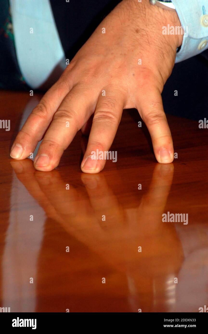 a hand touching wooden reflecting floor, human tactile and haptic ...