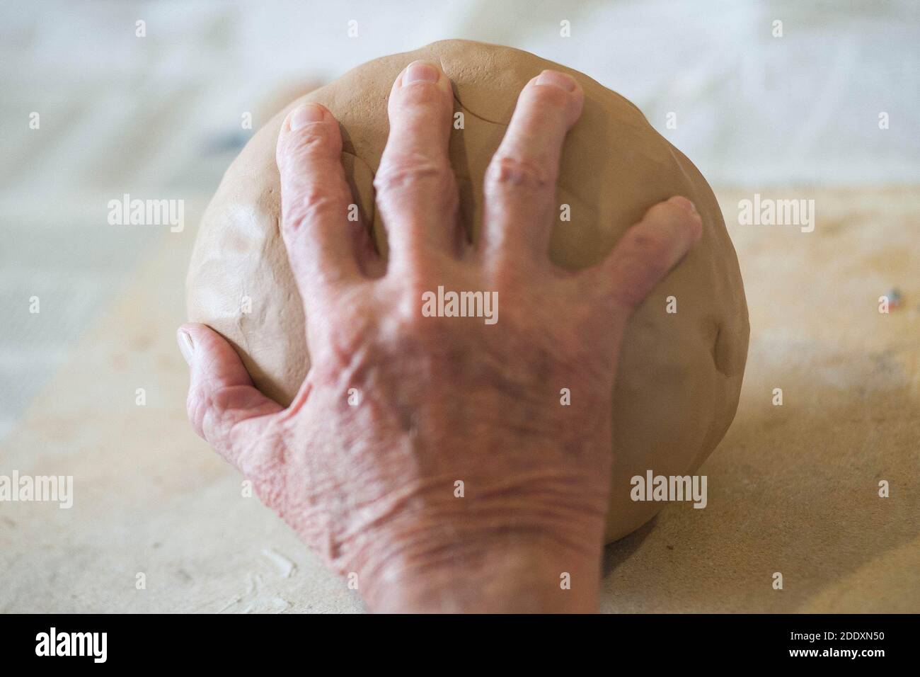 a hand touching a ball of clay, human tactile and haptic perception ...