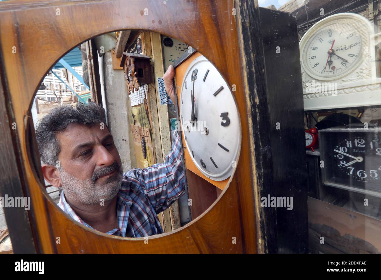 Baghdad. 27th Nov, 2020. Watch repairman Ali Mahmoud works in his shop ...