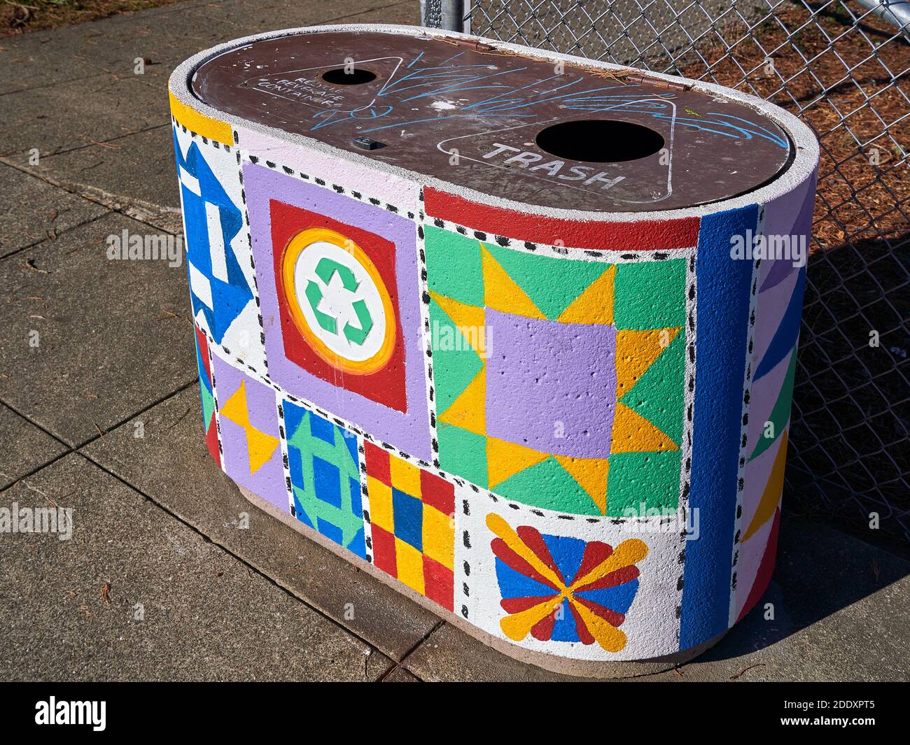 Trash and recycling waste bin painted in colorful style on a street in ...