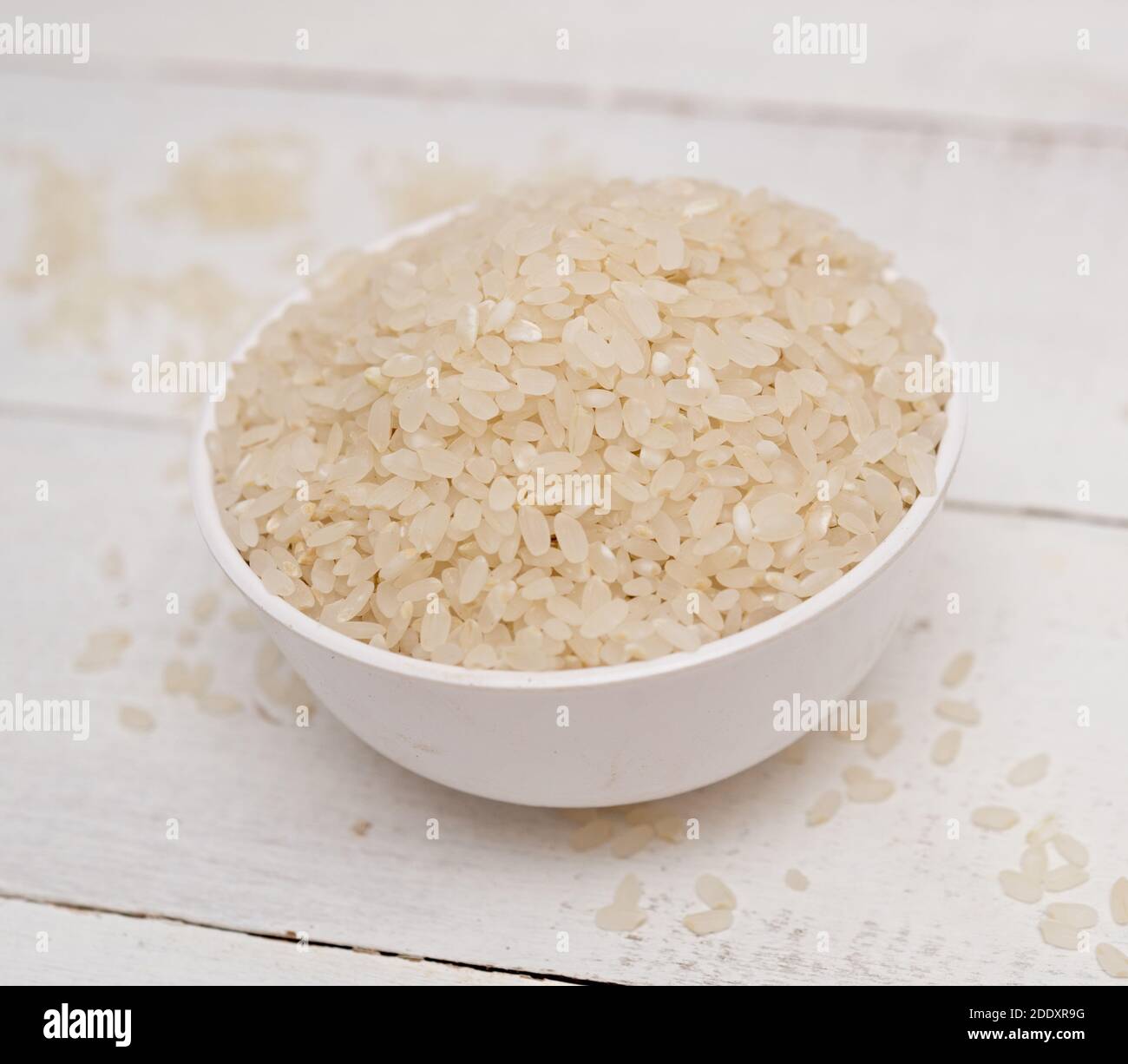 Uncooked rice on wooden background Stock Photo - Alamy