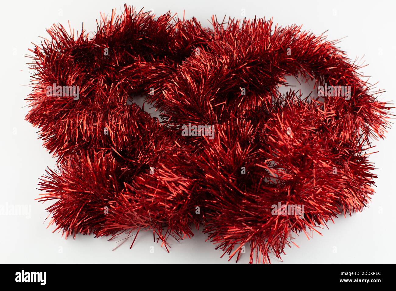 a red garland for christmas on a holiday background Stock Photo - Alamy