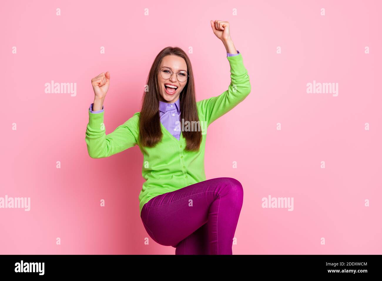 Portrait of ecstatic girl win raise fists scream isolated over pastel ...