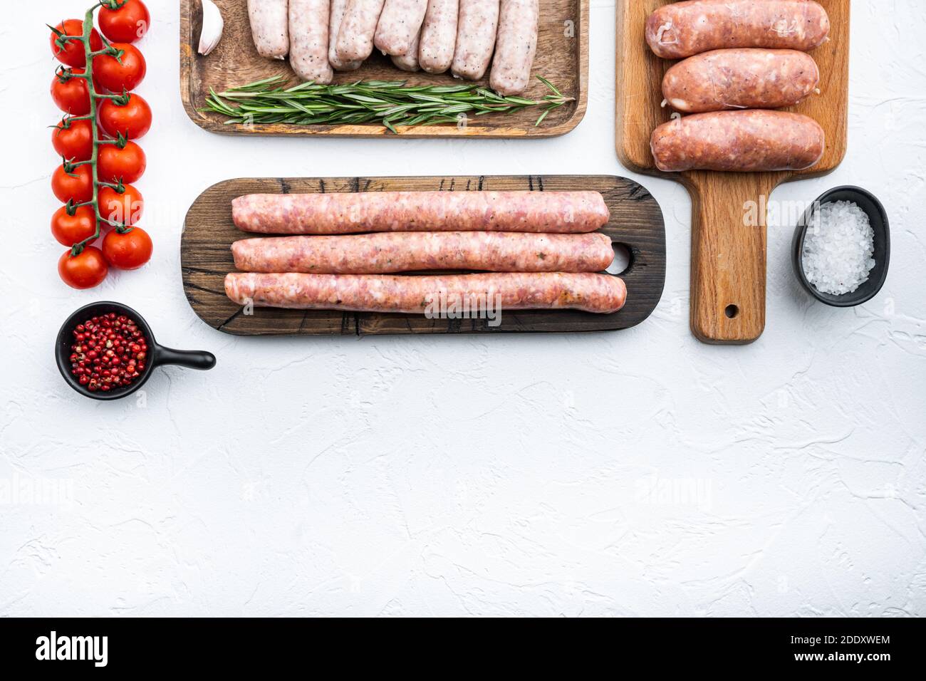 Raw sausages set, top view with space for text, on white background ...