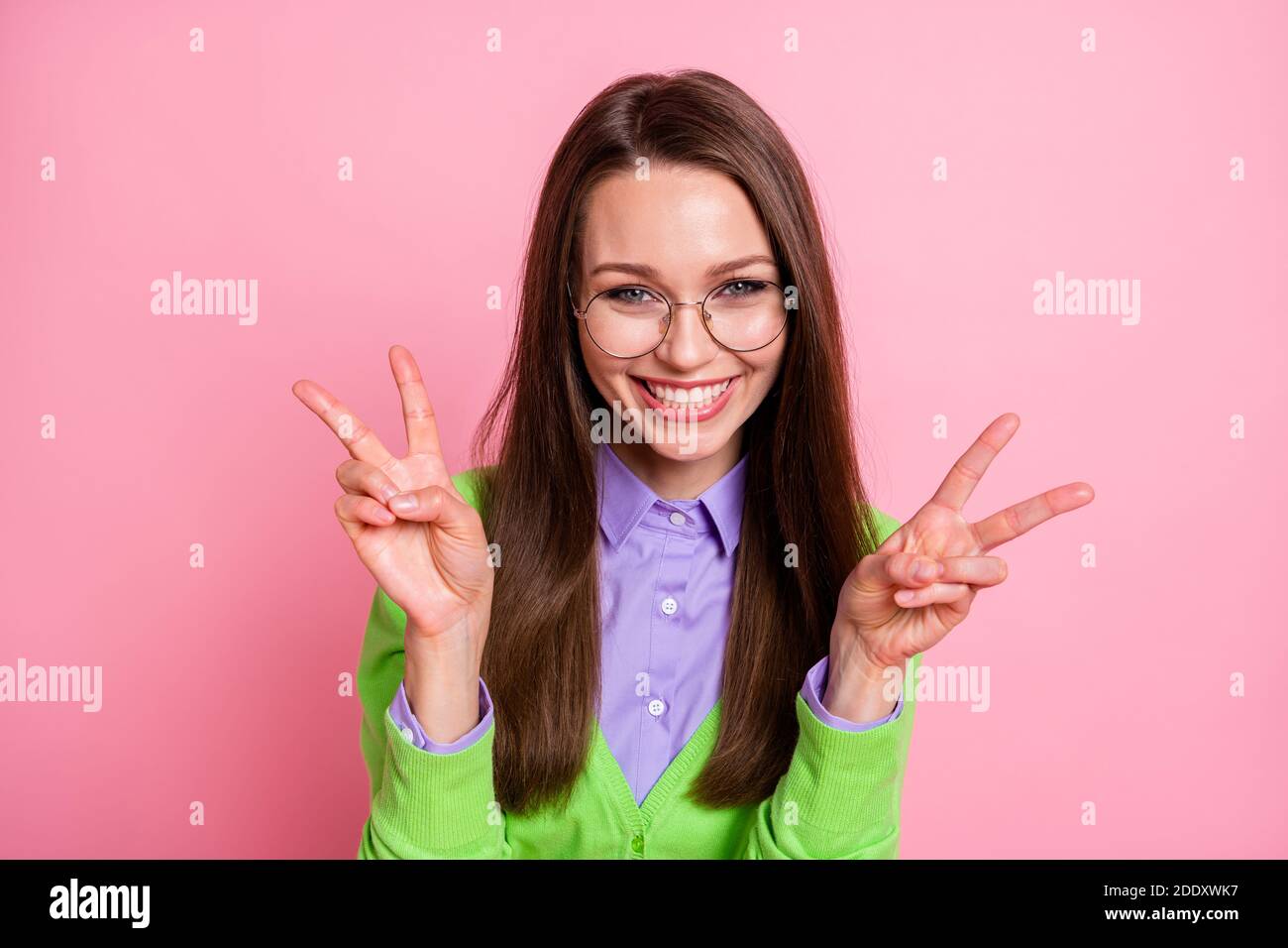 Portrait of pretty girl make v-sign wear teen style shine clothes ...
