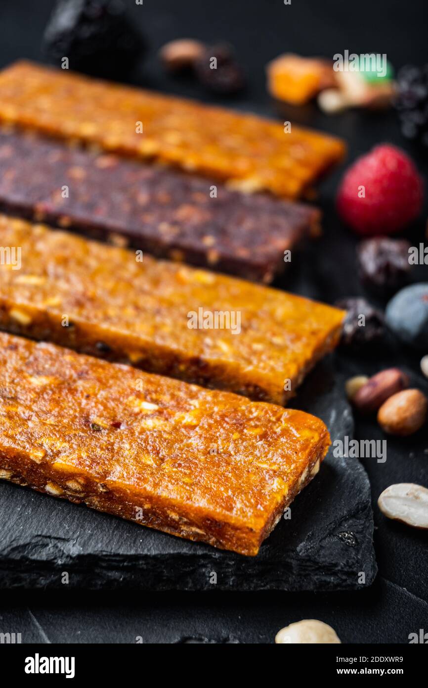 Fruit berry nut energy bars, healthy snack, on black background Stock ...