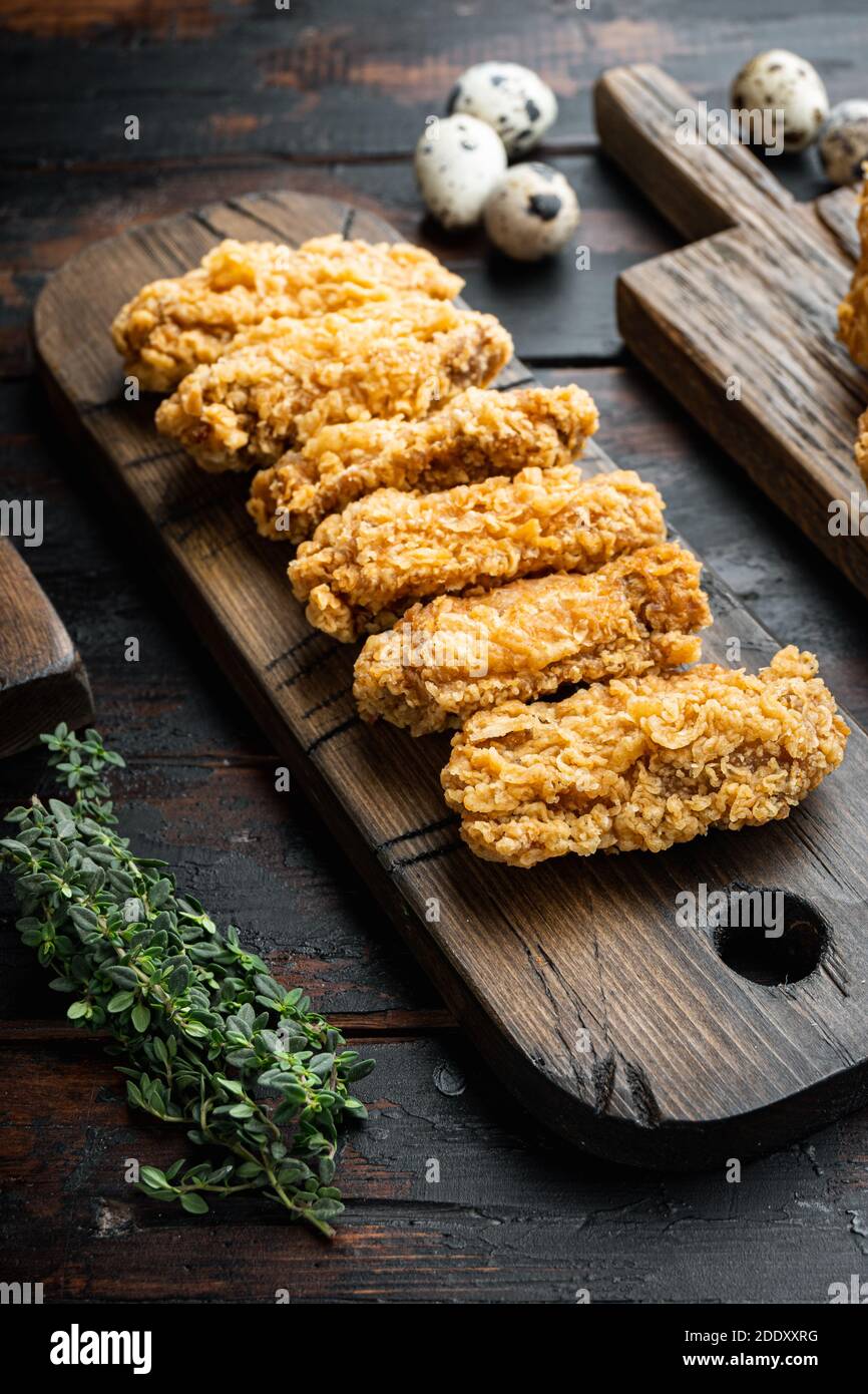 Fried chicken wings parts on dark wooden background Stock Photo - Alamy