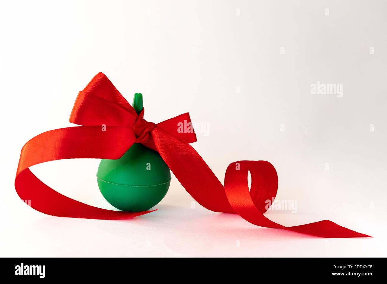 Green rubber bulb syringe with a red ribbon bow, medical holiday ...