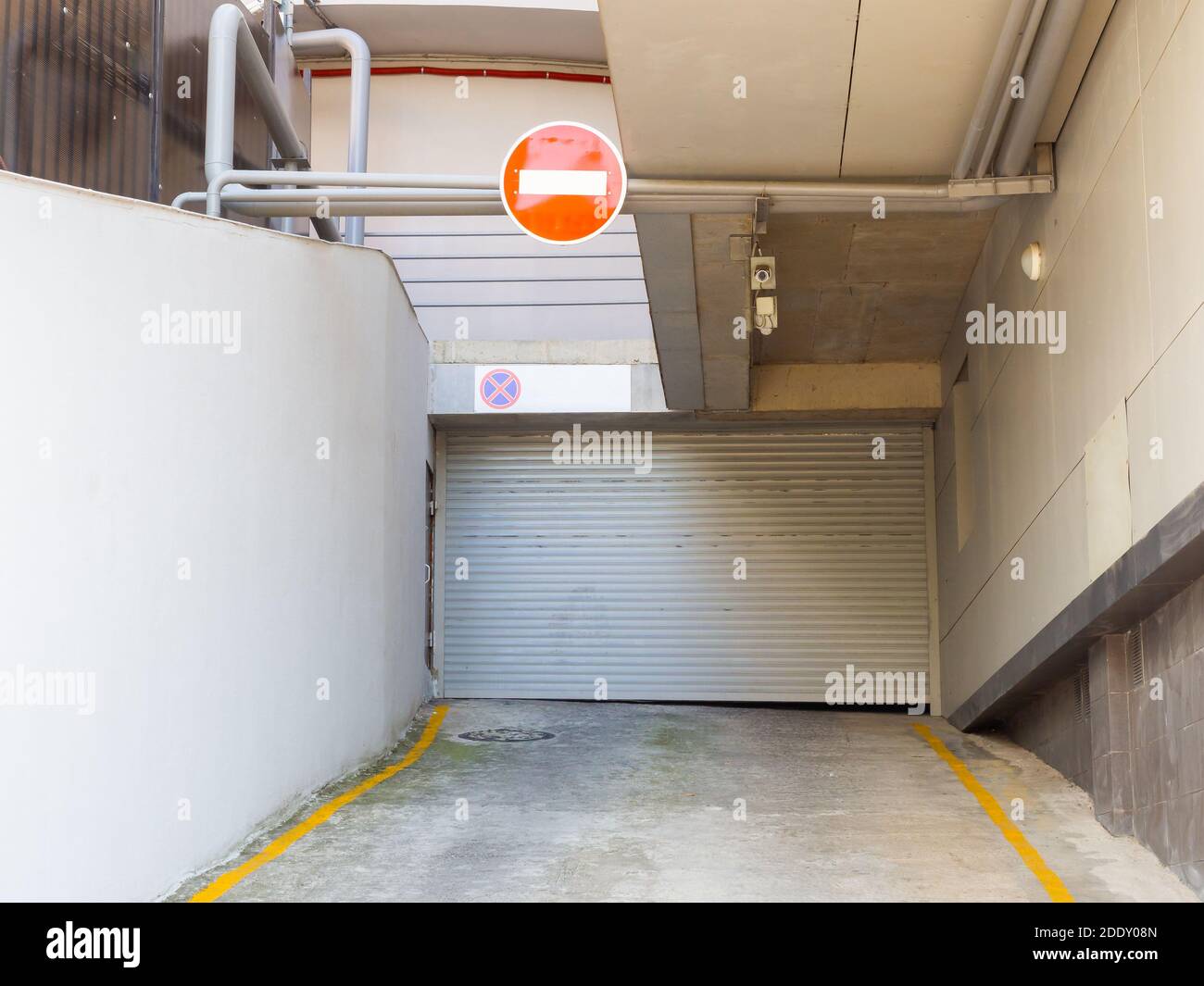 Entrance to the underground parking of the building with a closed ...