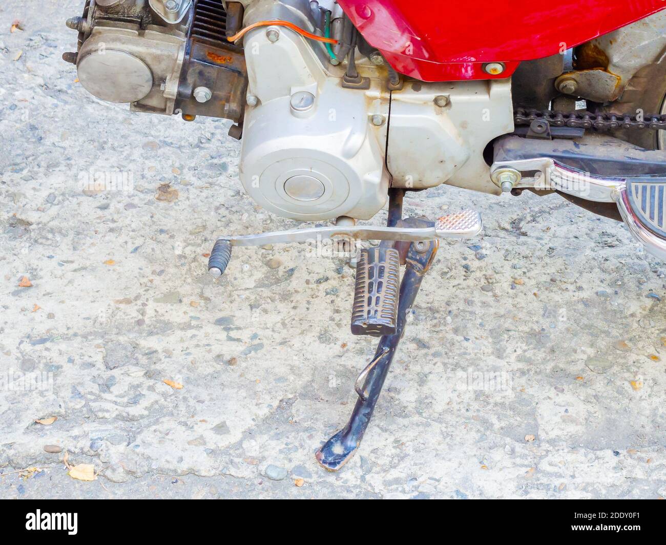 Close up photo of motorcycle running board standing on uneven asphalt ...