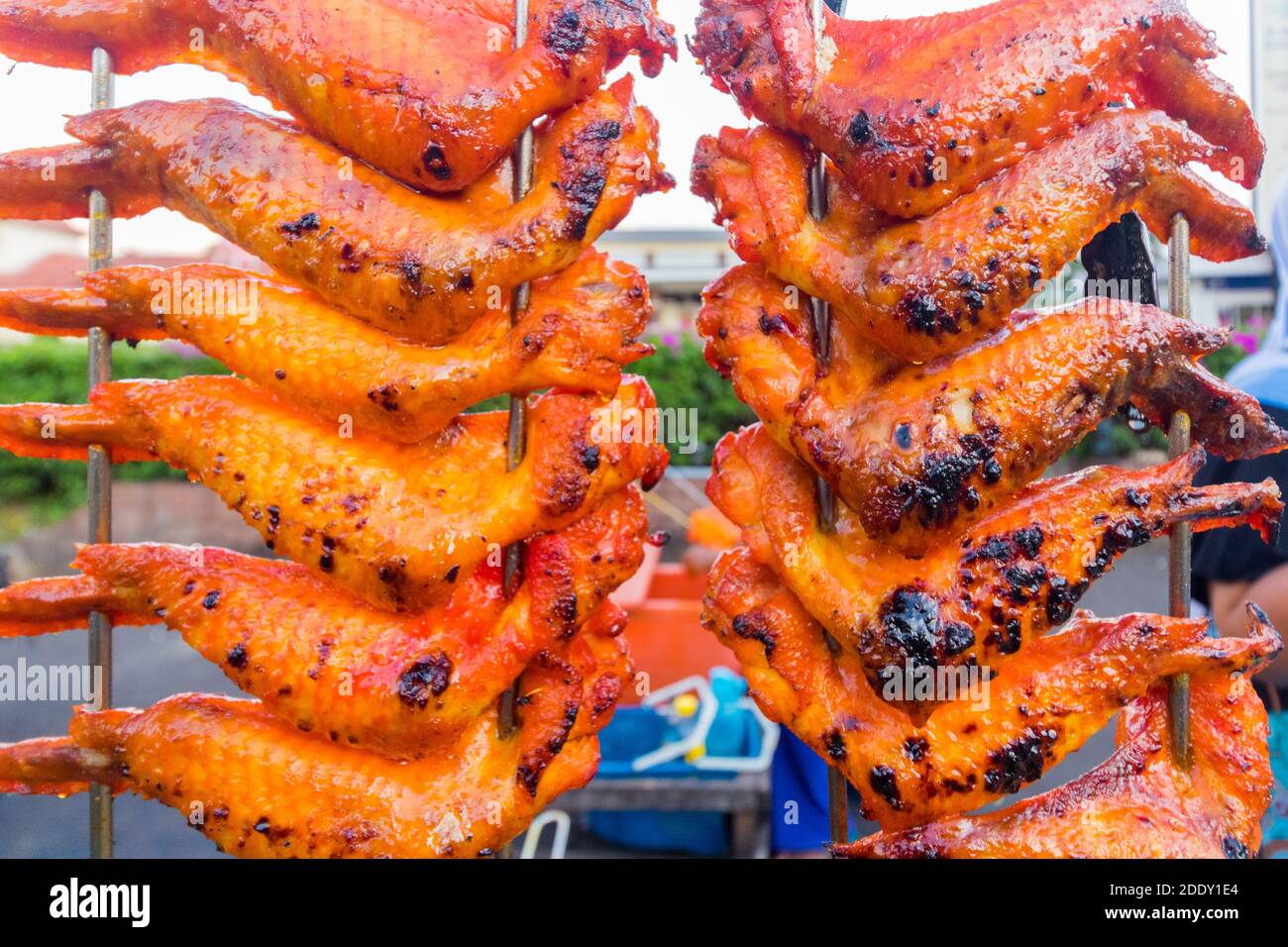 Grilled chicken parts at an open air night food restaurant in Tenom ...