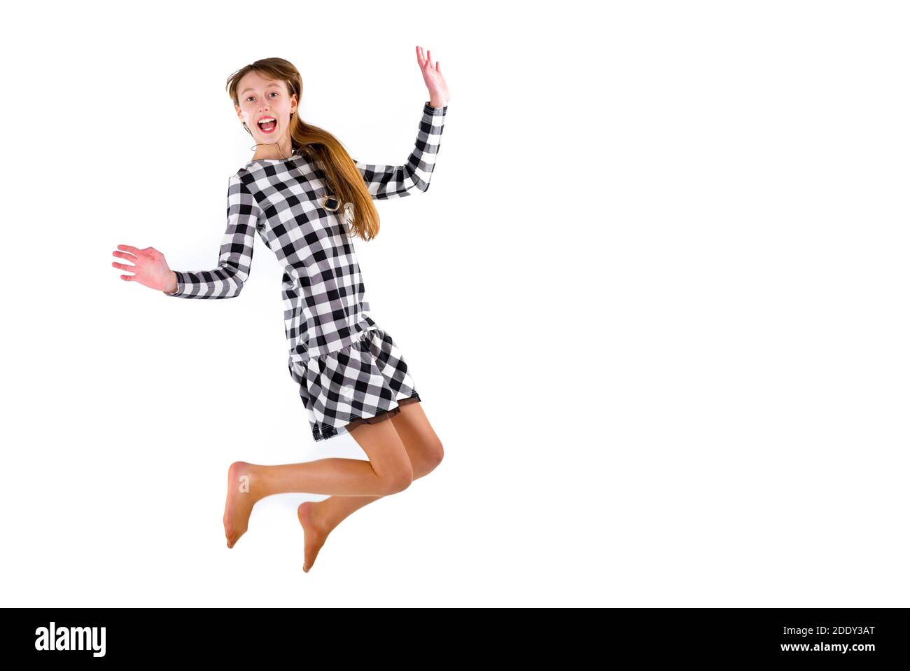 happy teen girl jumping up on white studio background.Copy space Stock ...