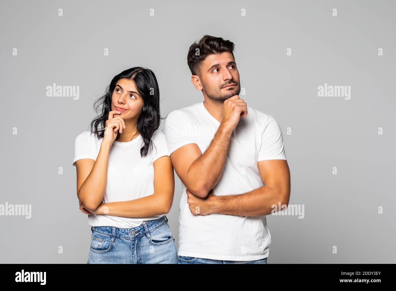 Couple thinking over isolated white background Stock Photo - Alamy
