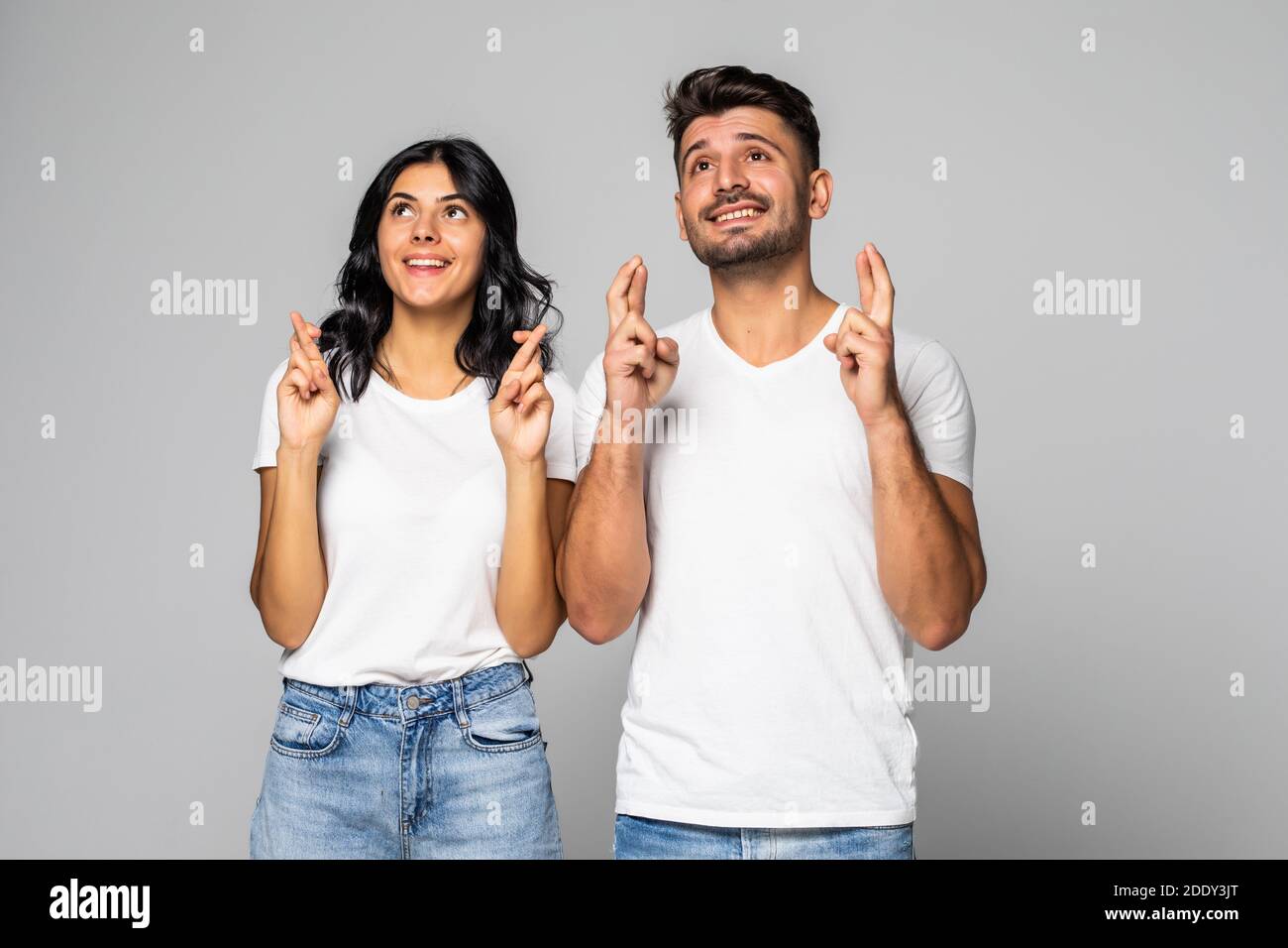 Superstitious young couple crossing fingers wish for good luck concept ...