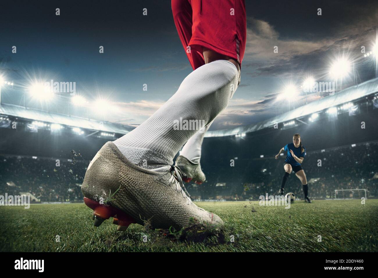 Frontal attack. Close-up leg football or soccer player at stadium in ...