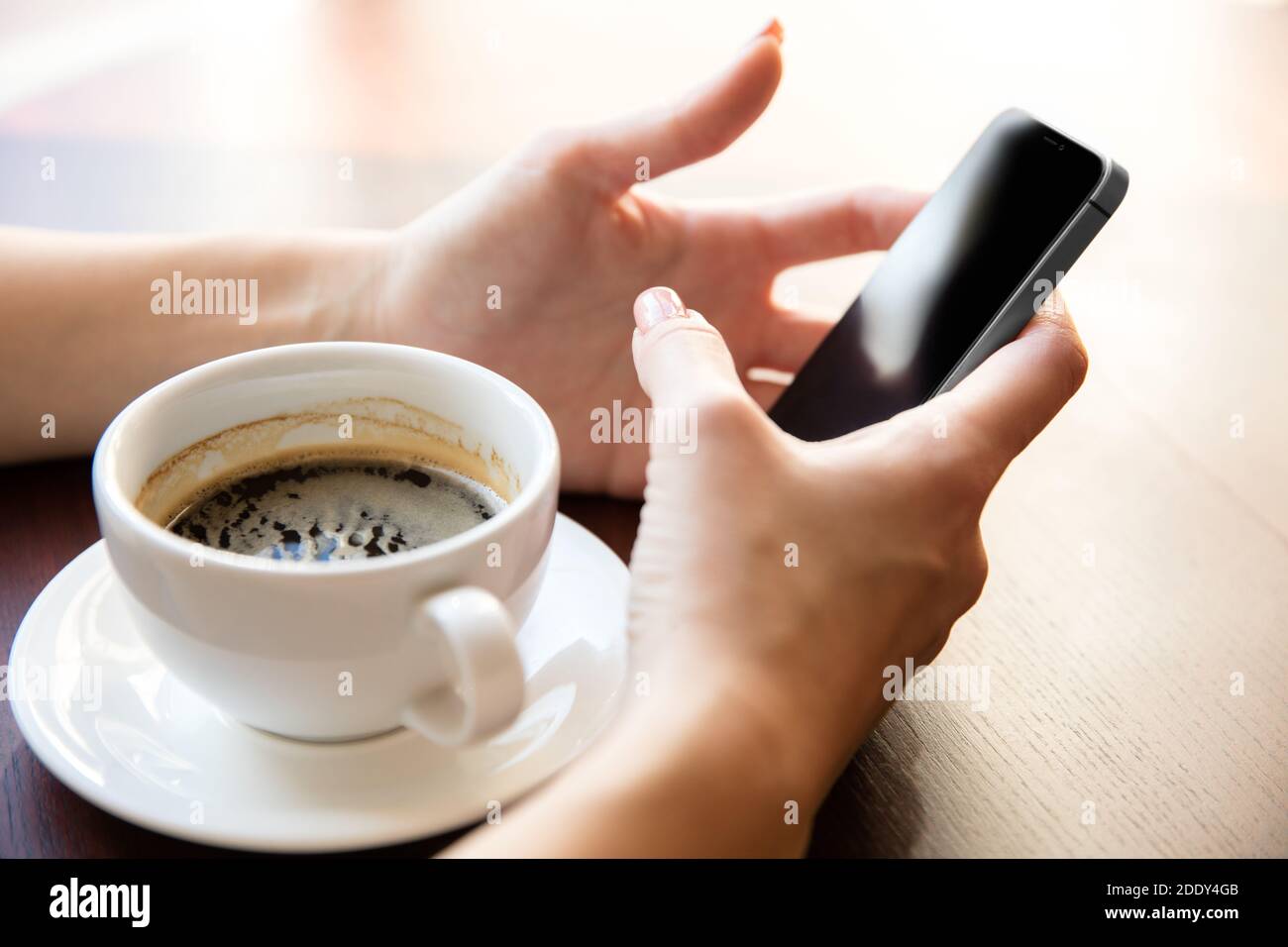 Female hands holding new model of mobile phone Stock Photo - Alamy