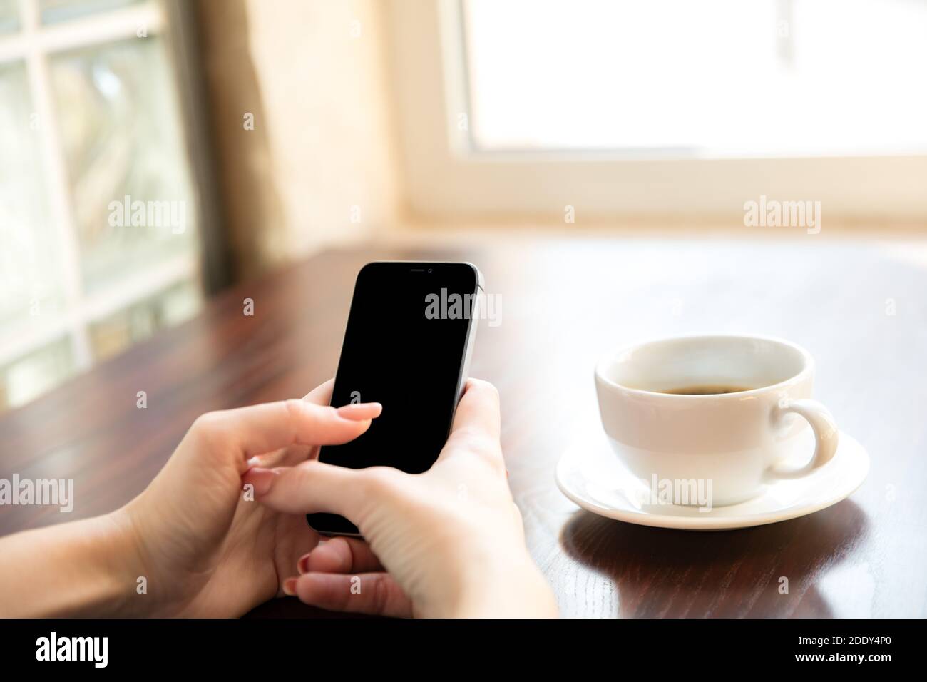 Female hands holding new model of mobile phone Stock Photo - Alamy