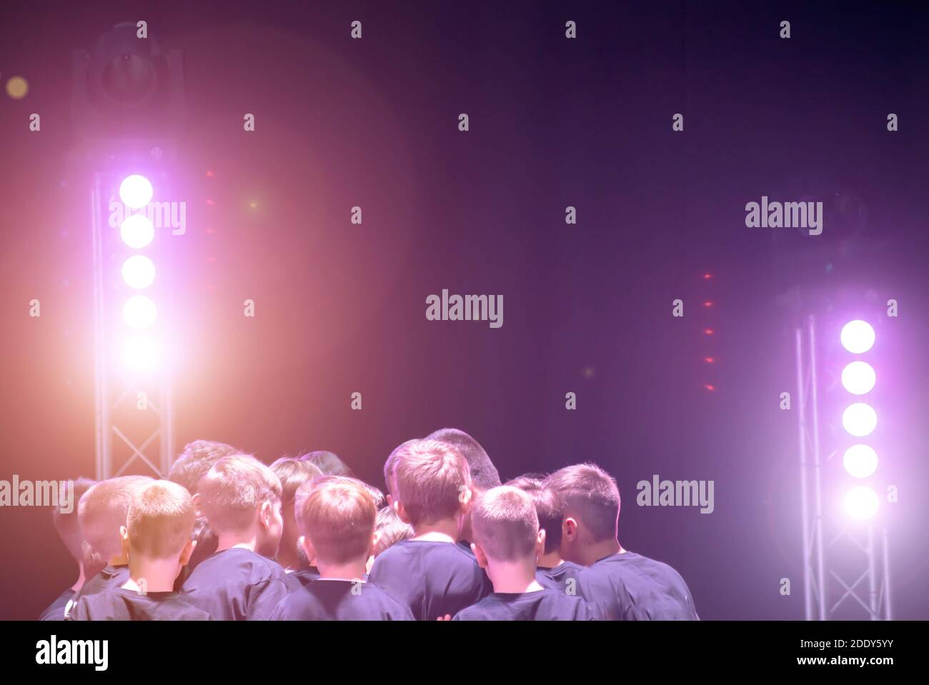 A group of children on stage are discussing something together Stock ...