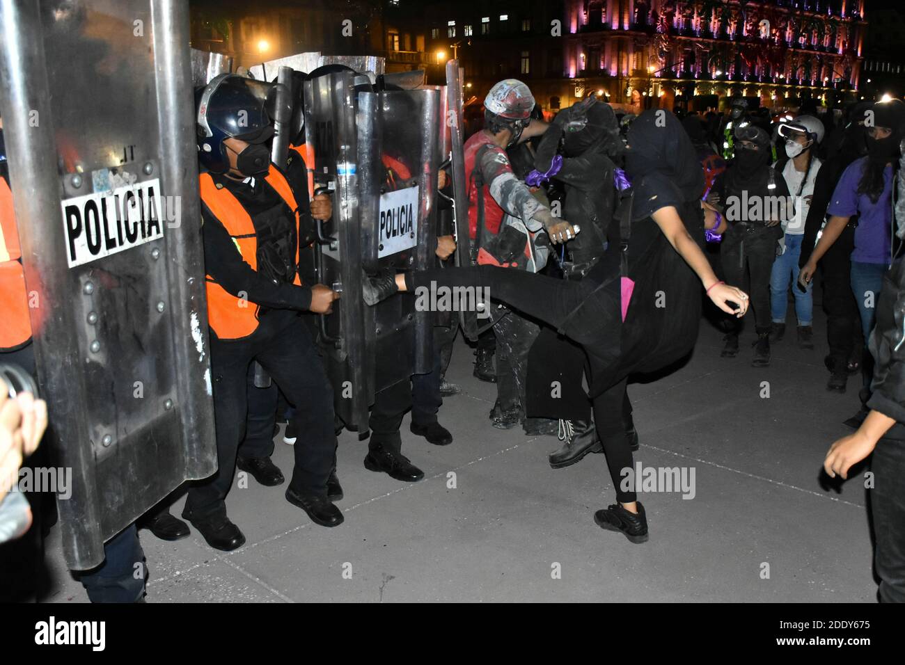 MEXICO CITY, MEXICO - NOVEMBER 25: A woman confronts a riot police line ...