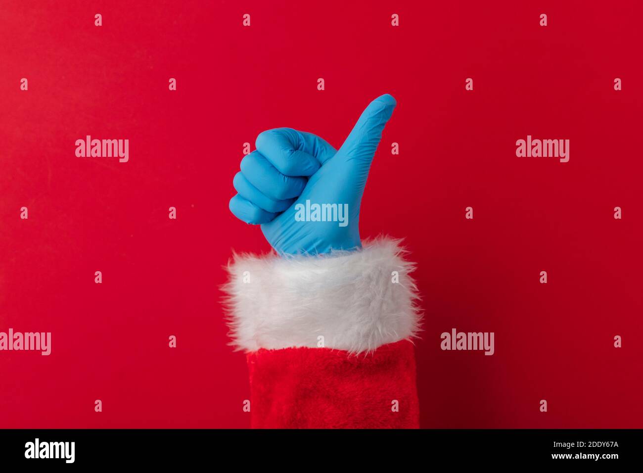 Santa hands wearing blue PPE protective gloves making thumbs up sign ...